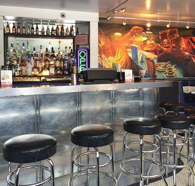 The bar area – where Art Deco meets liquid therapy with a mural that seems to say, "Stay awhile, the stories get better."