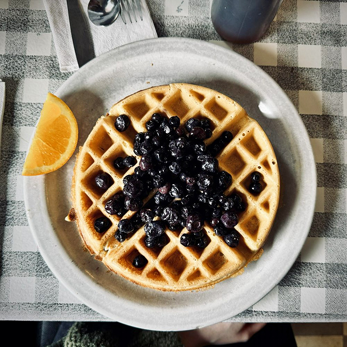 Waffle geometry at its finest. Those perfect squares cradle blueberries like nature's candy, waiting for maple syrup rainfall.