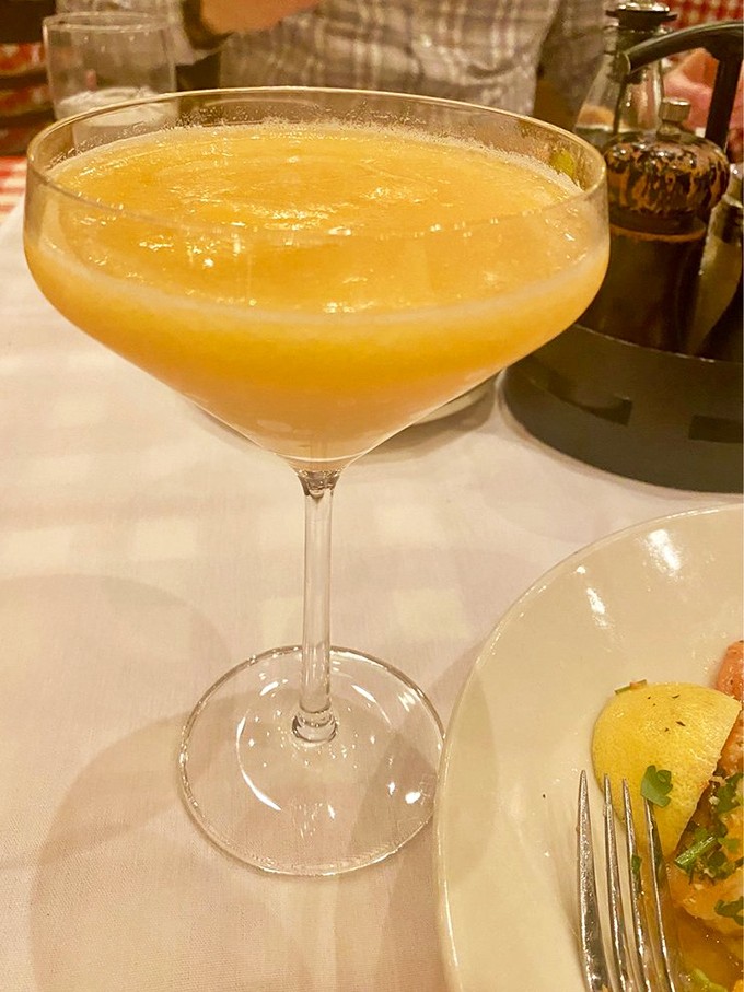 This Bellini isn't just a cocktail, it's liquid sunshine in a glass – peach purée and prosecco creating the kind of sunset you want to sip.