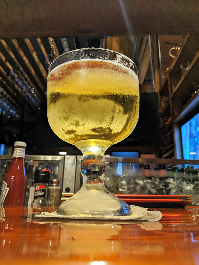 That's not just a beer—it's a goblet of golden happiness, served in a glass that suggests you're in for something special tonight.