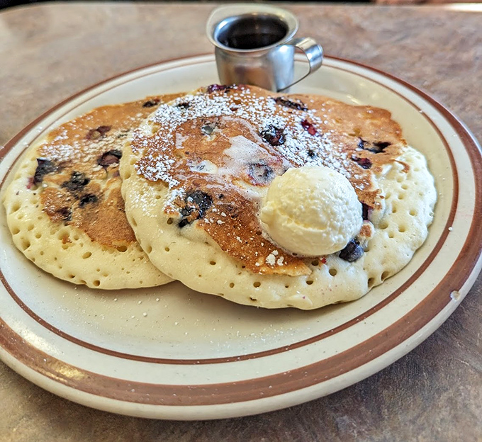Blueberry pancakes with a scoop of butter melting like a summer romance—breakfast as dessert is always the right choice.