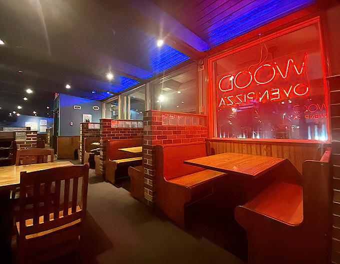 Mood lighting that says "stay awhile" and booths that practically whisper "one more slice won't hurt." The neon glow adds a touch of retro cool.