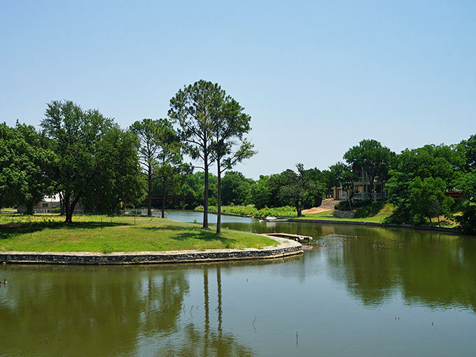 The tranquil Brazos River reflects towering trees along its banks, creating nature's perfect mirror for self-reflection or simply admiring the view.