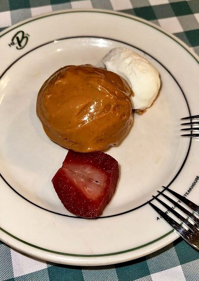 Dessert that makes you close your eyes involuntarily—caramel-kissed cake with a scoop of vanilla ice cream and fresh strawberry.