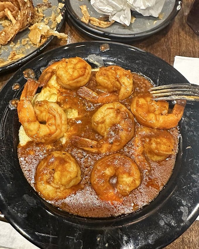 These shrimp aren't just swimming in sauce—they're doing the backstroke in flavor heaven. Cajun spices turn ordinary into extraordinary. Photo credit: Amber M.
