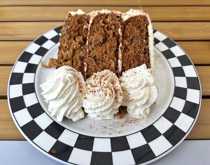 Carrot cake that actually makes you grateful for vegetables – three layers of spiced perfection crowned with pillowy cream cheese frosting.