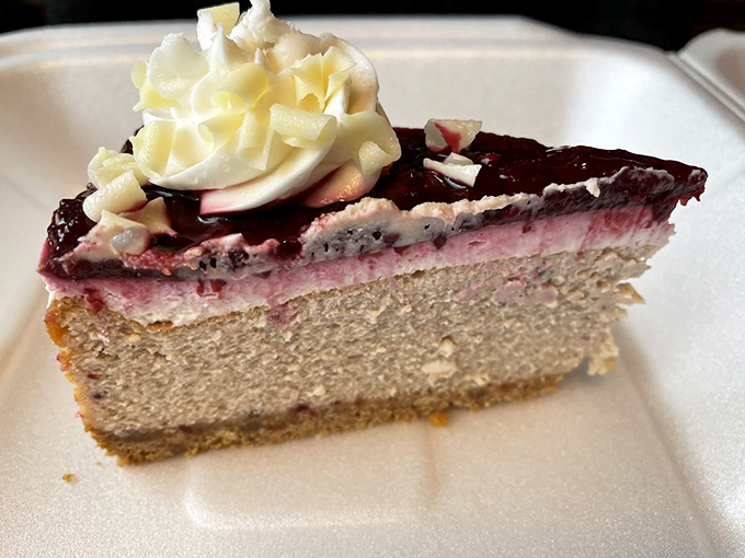 This isn't just cheesecake – it's a three-act play of creamy, fruity, and sweet that deserves a standing ovation and possibly an encore.