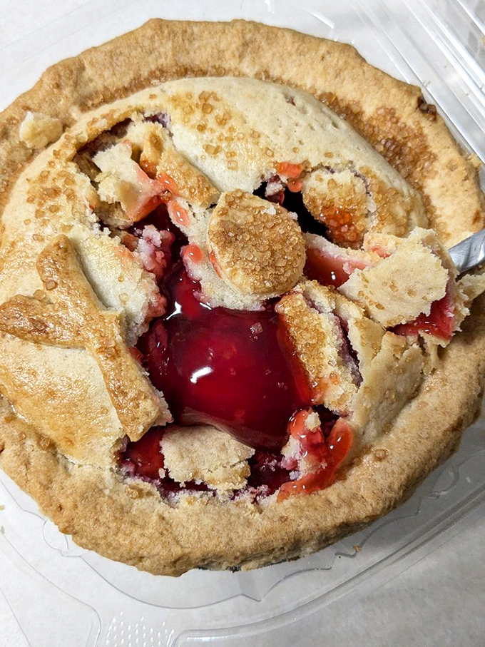 Cherry filling erupting through golden crust like nature's lava lamp. This isn't just a pie – it's a geological event worth documenting.