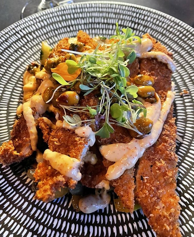 Crispy, golden-brown perfection topped with microgreens and sauce—proof that sometimes the most beautiful things in life are the crunchiest.