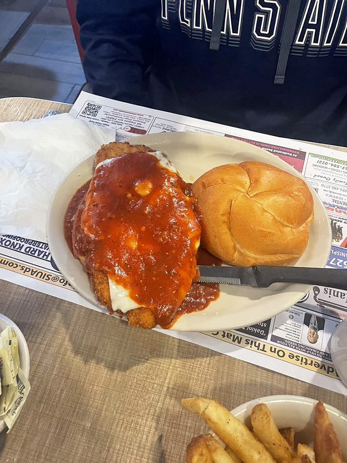 Chicken parm sandwich with sauce that doesn't know when to quit. That roll is just trying to contain the delicious chaos.