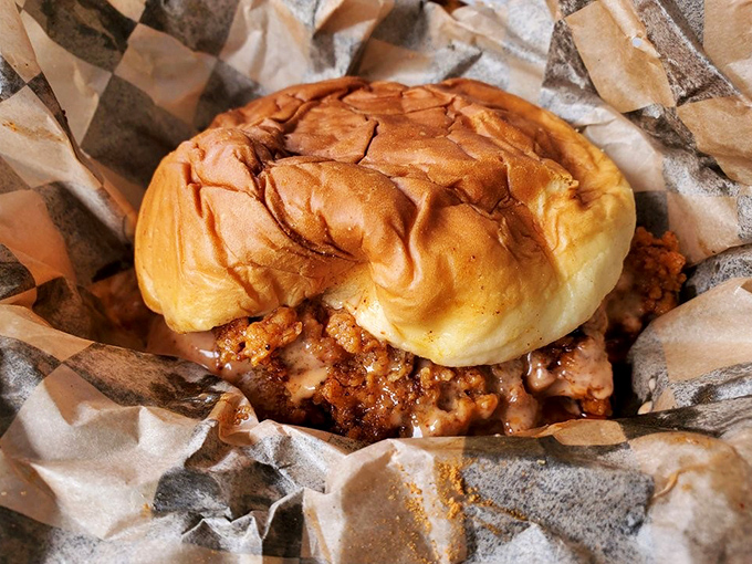 The chicken sandwich – a more manageable delivery system for that signature spice blend. The soft bun provides temporary refuge from the heat.