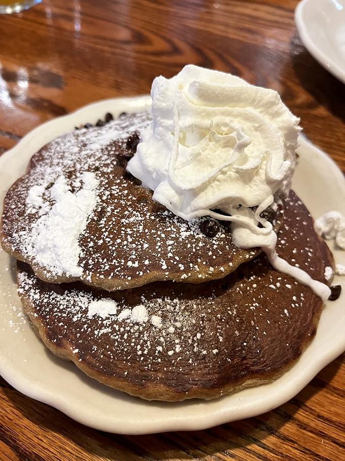 These chocolate pancakes with powdered sugar and whipped cream aren't just breakfast – they're the reason alarm clocks were invented.