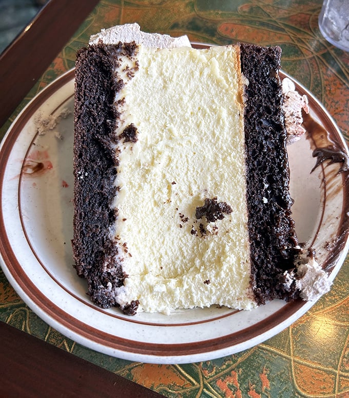 This isn't just chocolate cake—it's a layer cake masterpiece with what appears to be cream filling that demands to be savored one deliberate bite at a time.