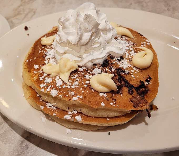 Chocolate chip pancakes with whipped cream—the breakfast that makes adults remember why being a kid was so wonderful.