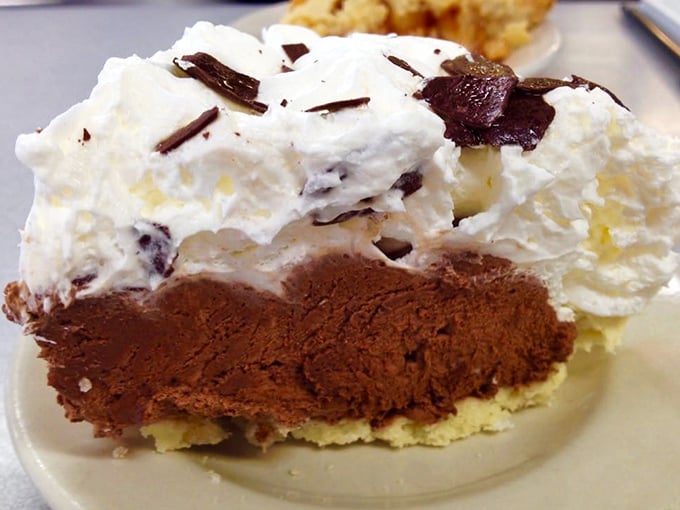 This isn't just pie—it's a three-layer chocolate dream that makes people temporarily forget their table manners.