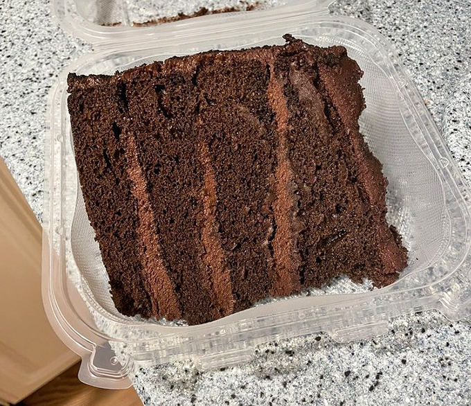 Chocolate cake that doesn't need fancy plating or edible flowers—just layer upon layer of cocoa commitment that demands to be taken home.