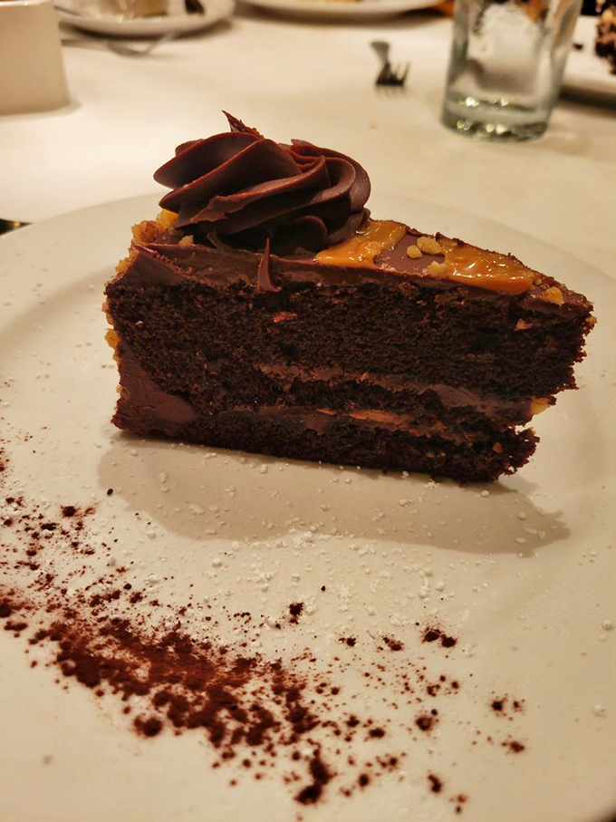 A chocolate torte that deserves its own Instagram account—layers of decadence with caramel that would make you lick the plate if no one was looking.