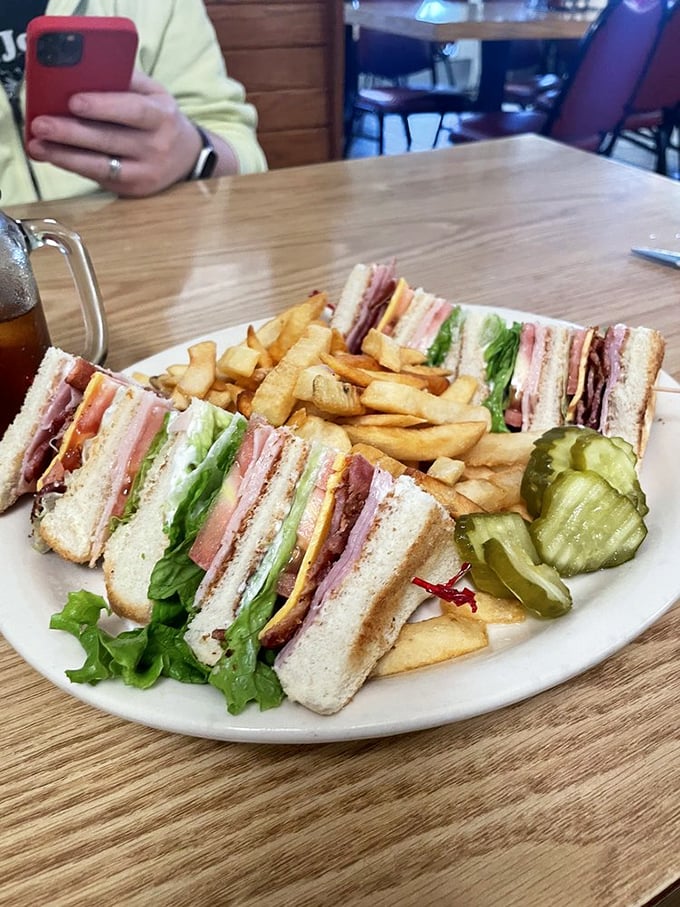 The club sandwich – America's boardroom lunch transformed into an architectural marvel of bread, meat, and vegetables that actually tastes good.