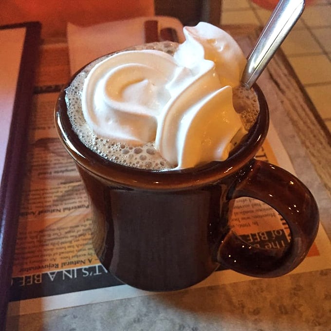 Hot chocolate that wears its whipped cream crown with pride—the kind that makes you wonder why adults ever stopped ordering it in the first place.