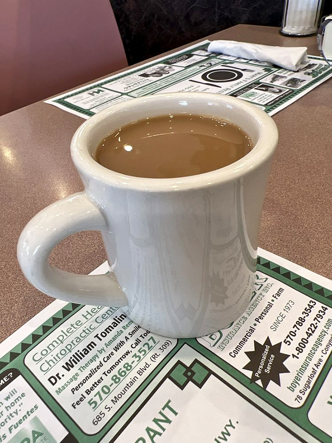 This isn't just coffee—it's liquid motivation in a sturdy white mug, ready to transform morning grumbles into actual human conversation.