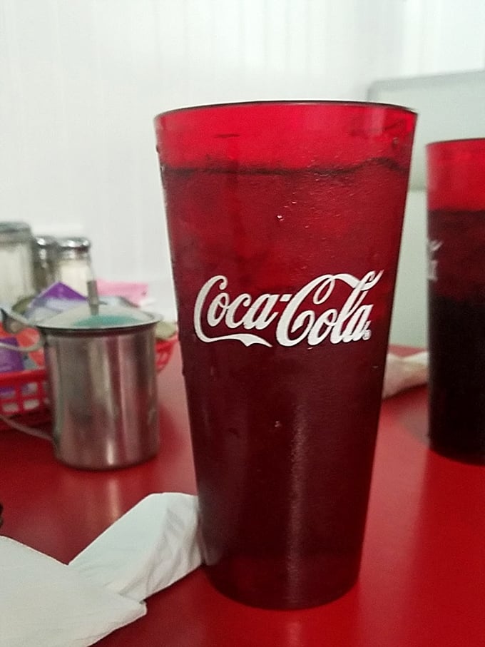 That classic red cup of cola—where the condensation on the outside is like nature's way of applauding your beverage choice.