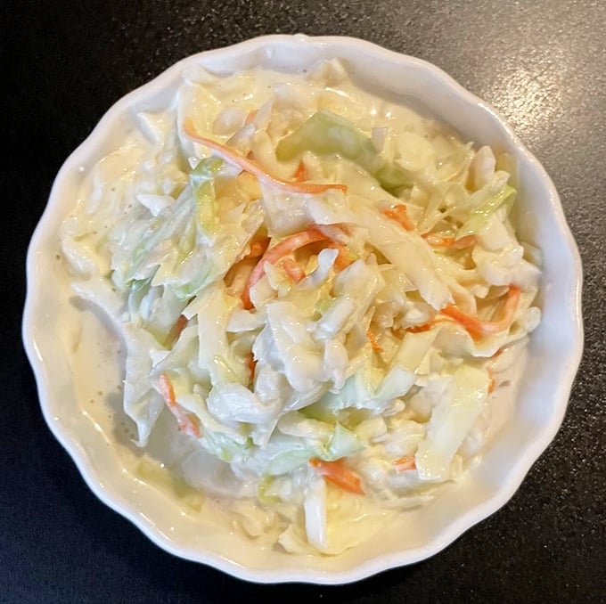 Coleslaw that actually deserves space on your plate – creamy, crunchy, and the perfect counterpoint to all that glorious fried goodness.