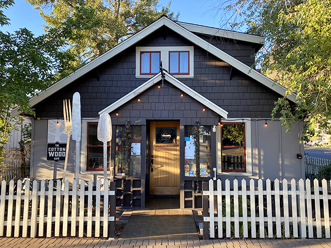 Cottonwood Cafe's charming facade hiding culinary treasures within. That white picket fence isn't just decorative—it's containing all the small-town perfection.