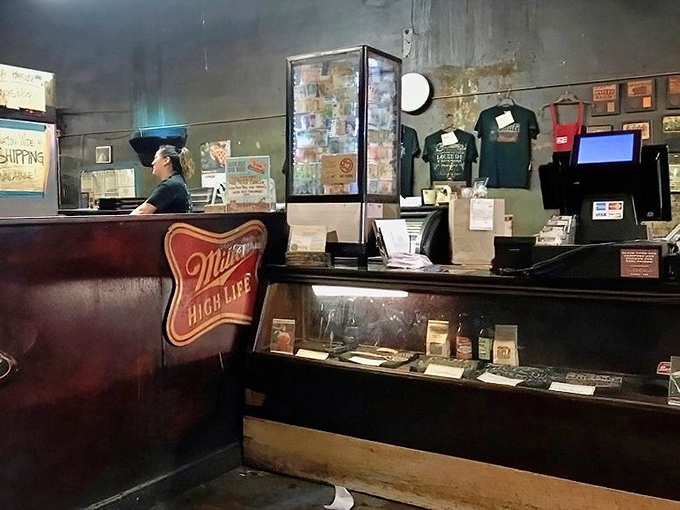 The counter where barbecue dreams come true. That Miller High Life logo isn't just decoration – it's a promise of authenticity.