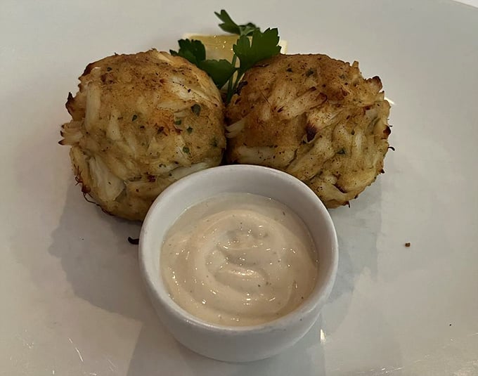 These crab cakes are what Maryland dreams about—mostly crab, minimal filler, and a sauce that makes you want to lick the plate.