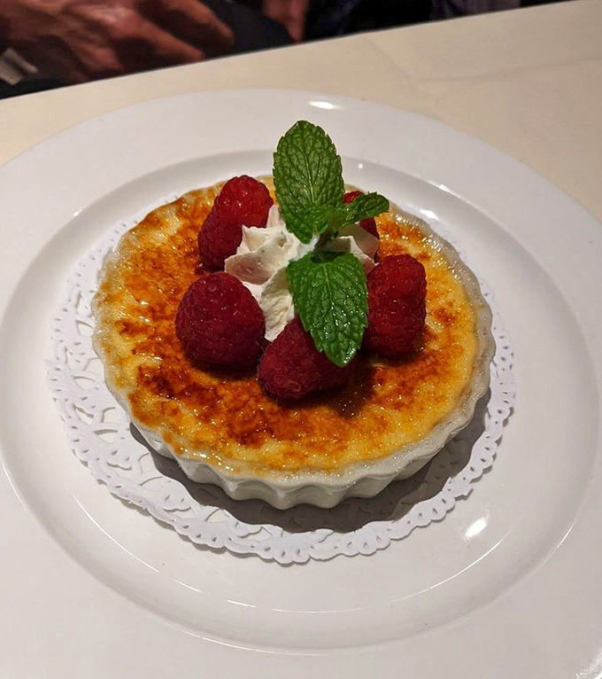 Crème brûlée with fresh raspberries—that perfect crack of caramelized sugar is the percussion section of the dessert symphony.