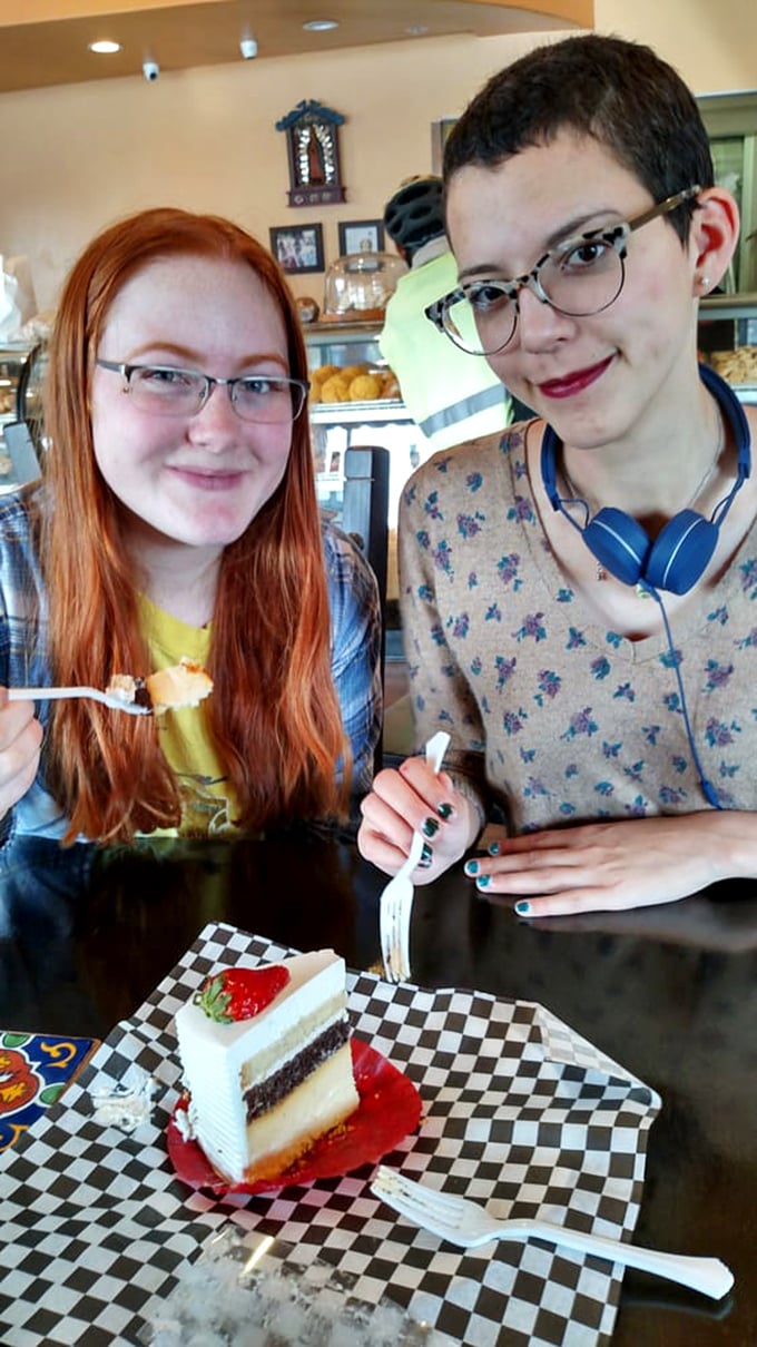 Happy customers experiencing that universal moment of pre-bite anticipation. Some food memories aren't just made—they're carefully constructed, one forkful at a time.