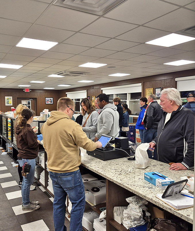 The pilgrimage to the counter – where strangers become united in their quest for the perfect fried dough experience.