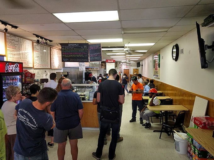 The lunch line of anticipation—where strangers become comrades united by the universal language of impending sandwich satisfaction.