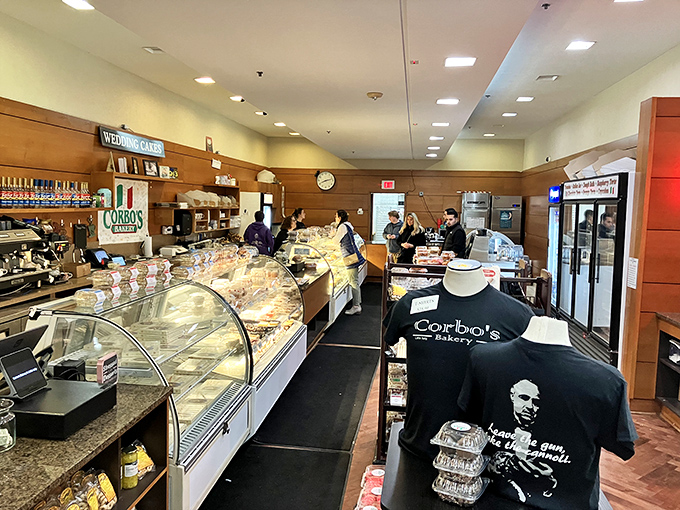 A bustling interior where tradition meets commerce. The curved display cases showcase treasures more valuable than gold—if you measure value in butter and sugar.