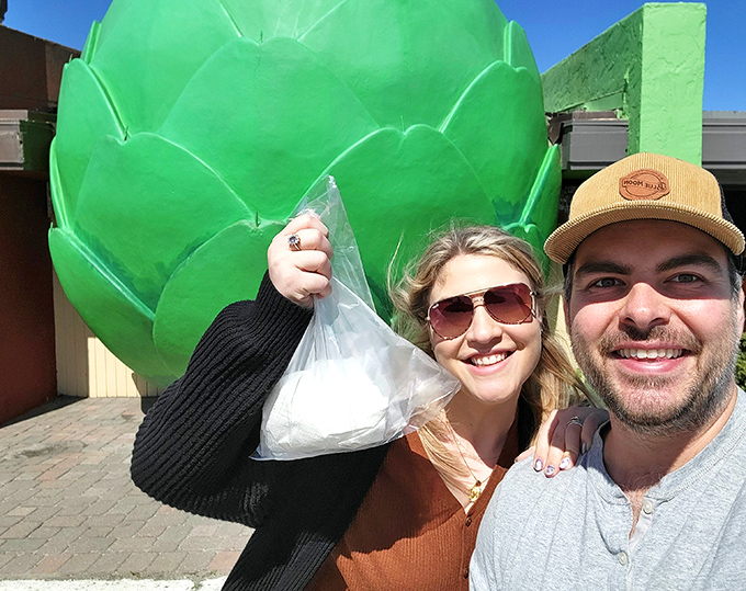 The giant artichoke isn't just a landmark—it's a mandatory selfie spot. Visitors proudly display their takeout treasures before heading back on the road.
