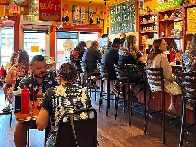 Locals crowd the bar, united in the universal language of hot dog appreciation—a community built on shared love for creative comfort food.