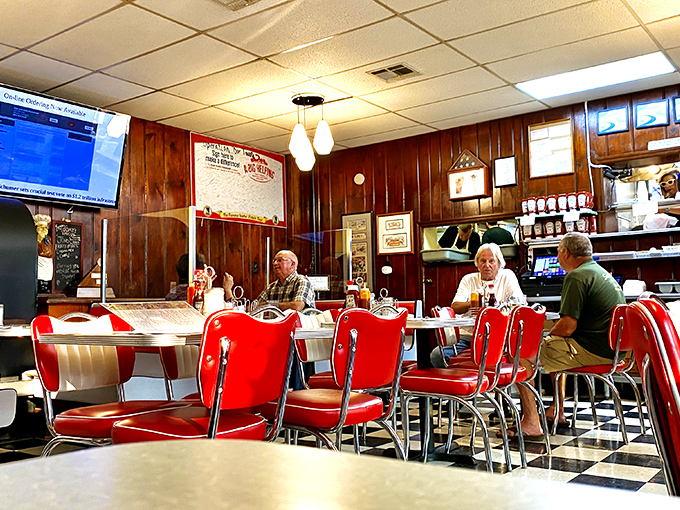 The breakfast counter—where strangers become neighbors and neighbors become friends. Those red chairs have heard more town gossip than any therapist.