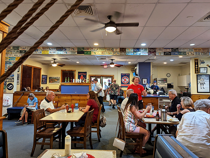 Where locals and tourists unite under the common flag of exceptional seafood. Notice the license plates lining the walls—souvenirs from fellow pilgrims.