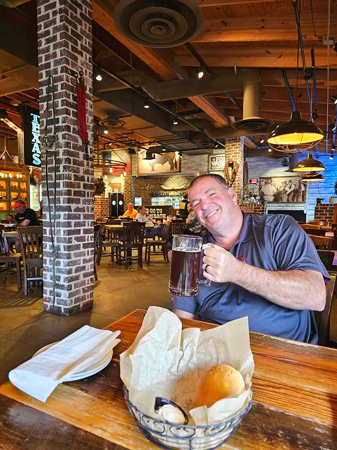 Cold beer, warm bread, and that look of anticipation—the universal expression of someone about to experience serious steak satisfaction.