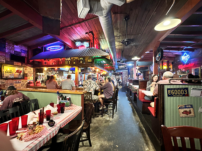 Where neon signs cast their glow over happy diners, creating that perfect roadhouse atmosphere where strangers become friends over shared appreciation for good food.