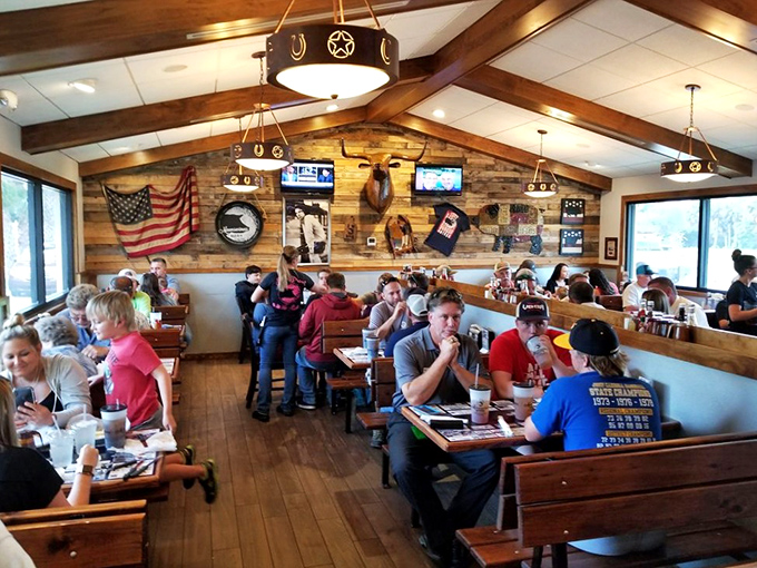 A packed house of BBQ pilgrims enjoying the fruits of low-and-slow cooking. Notice nobody's looking at their phones—meat commands full attention here.