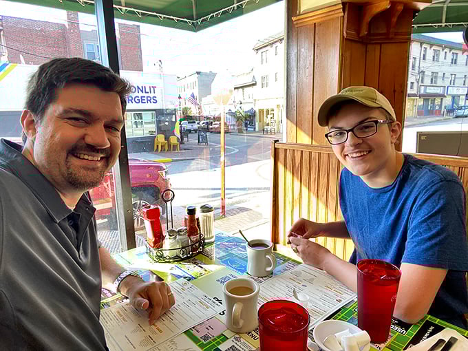 Happy diners plotting their next food move. That look of anticipation is universal – breakfast excitement knows no age limits.