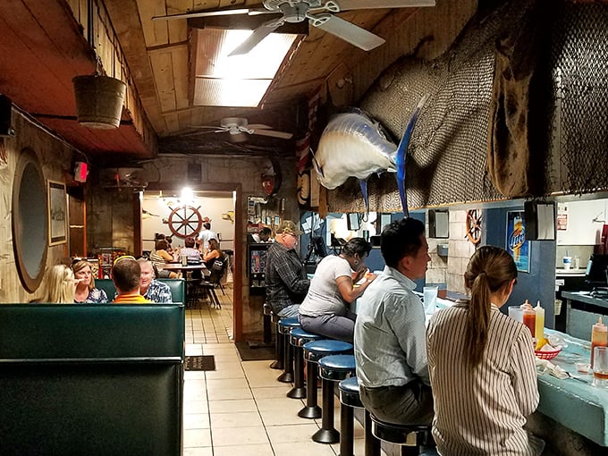 The oyster bar in full swing—where strangers become friends over shared condiments and seafood stories. Community building, one shell at a time.