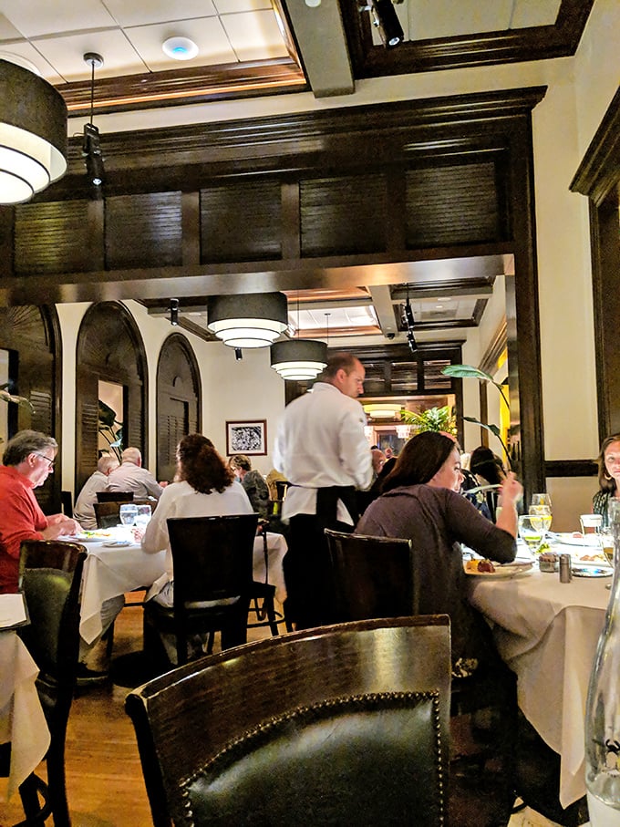 The true mark of a great restaurant: happy diners lost in conversation while attentive servers orchestrate culinary magic in the background.