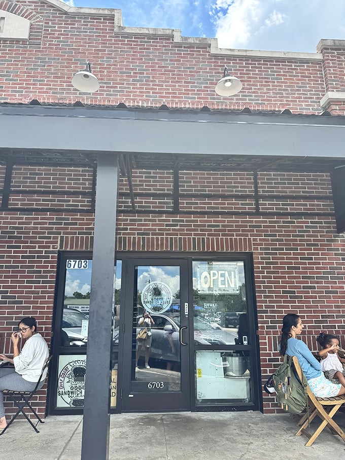 The storefront's simple brick exterior belies the bread magic within, while outdoor seating invites you to savor your sandwich in Florida sunshine.