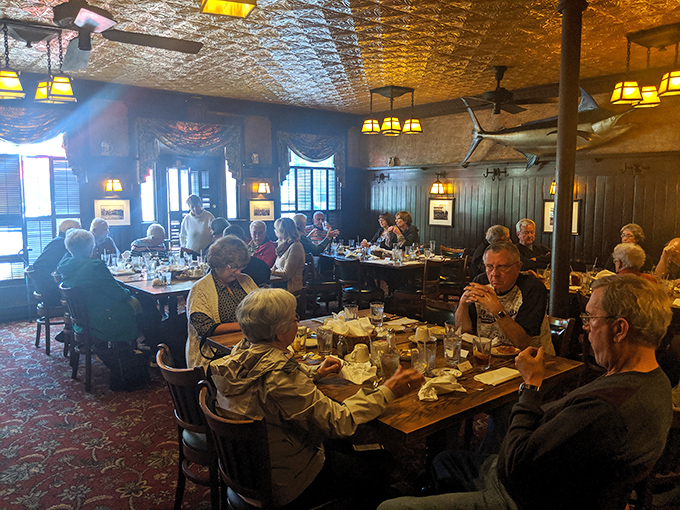 Where memories are made between bites—diners sharing stories and laughter under the warm glow of vintage lighting.