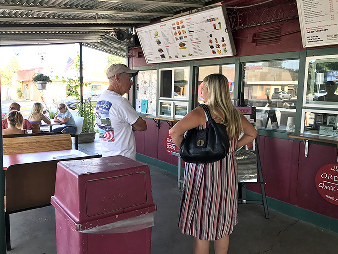 The universal language of anticipation—hungry customers plotting their order strategy like generals before battle.