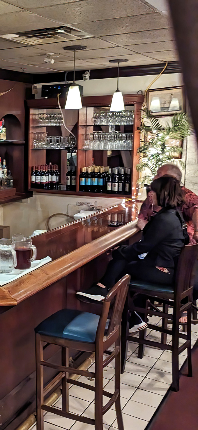 The bar area—where strangers become friends and friends become family over properly poured drinks and the promise of excellent food.