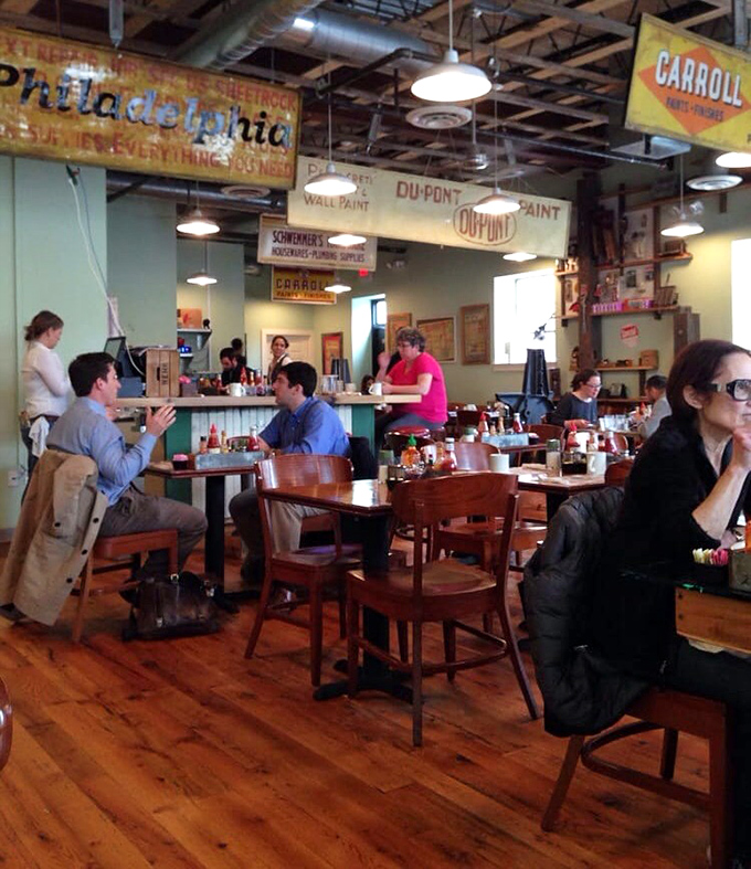 Vintage signs overhead tell Philadelphia's story while diners below create their own – conversations flowing as freely as the coffee refills.