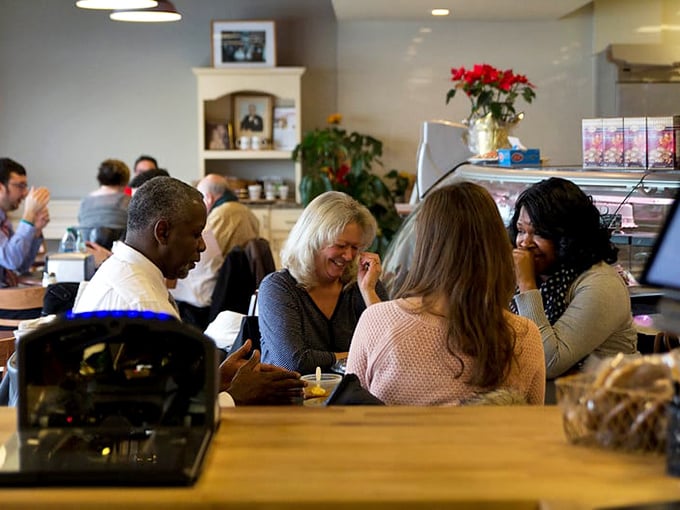 The universal language of good food bringing people together. These folks aren't just eating lunch—they're having a moment worth remembering.